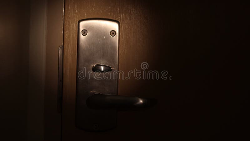 The Light of the Flashlight is Moving on the Closed Door Lock Stock ...