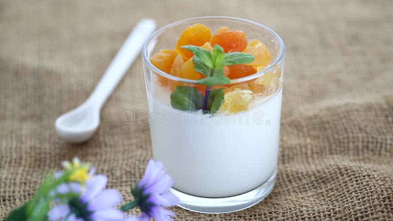 Light Fruit Yogurt with Dried Apricots on Dark Wooden Table Stock Video ...