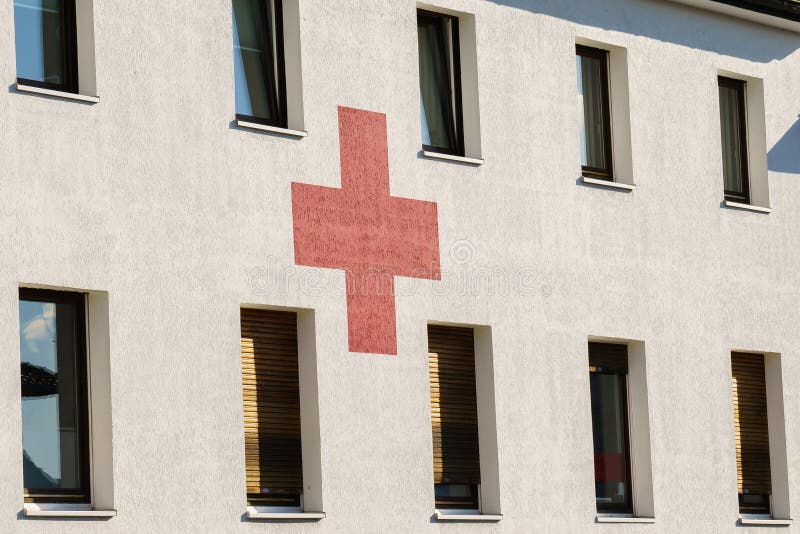 Light Gray Wall of a Building with the Symbol of the Red Cross. the ...