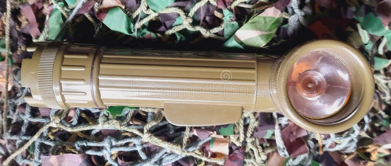 A Light Green Flashlight on a Rope and Pieces of Cloth the Color of an ...