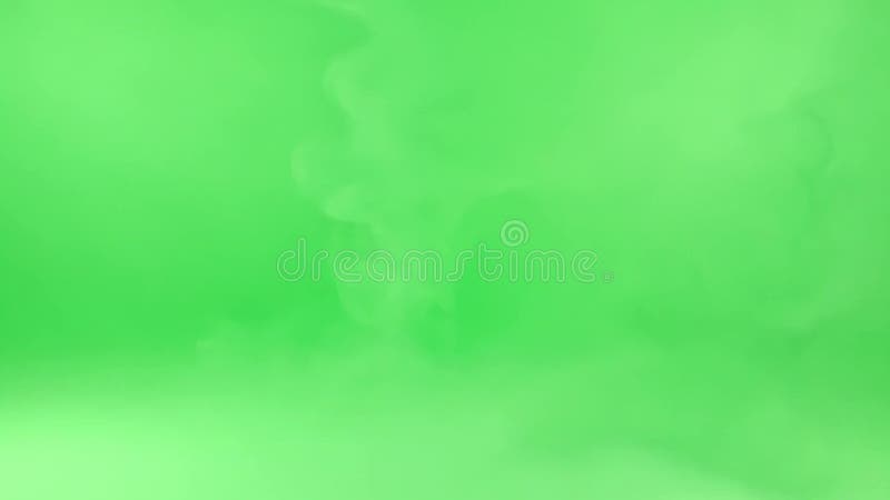 Light Green Smoke Floating and Swirling Against a Solid Green ...
