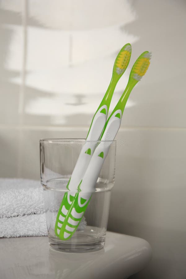 Light Green Toothbrushes in Glass Holder on Washbasin Stock Image ...