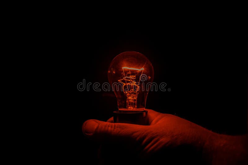 The Light from the Incandescent Lamp in the Hands Stock Photo - Image ...