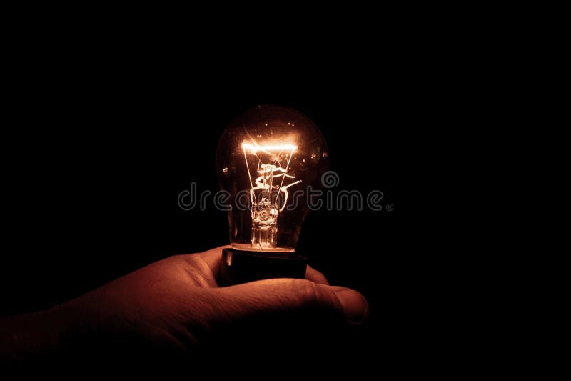 The Light from the Incandescent Lamp in the Hands Stock Photo - Image ...