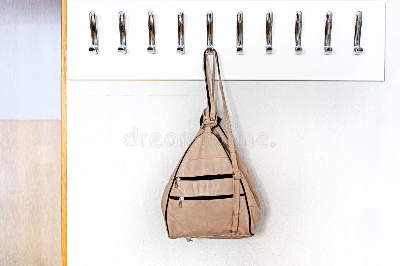 Light Leather Backpack Hanging on a Hanger with Metal Hooks in a ...