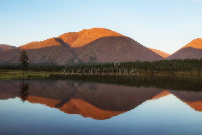 The Light of the Low Sun on the Top of the Mountain. Stock Photo ...