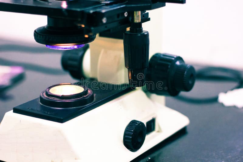 A Light Microscope with Knobs and Screws with Light on Stock Photo ...
