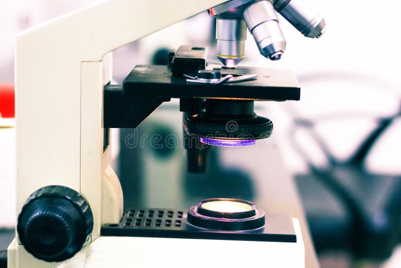 A Light Microscope with Knobs and Screws with Light on Stock Photo ...