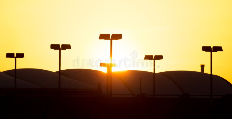 Light poles at sunset stock image. Image of electrical - 106390981