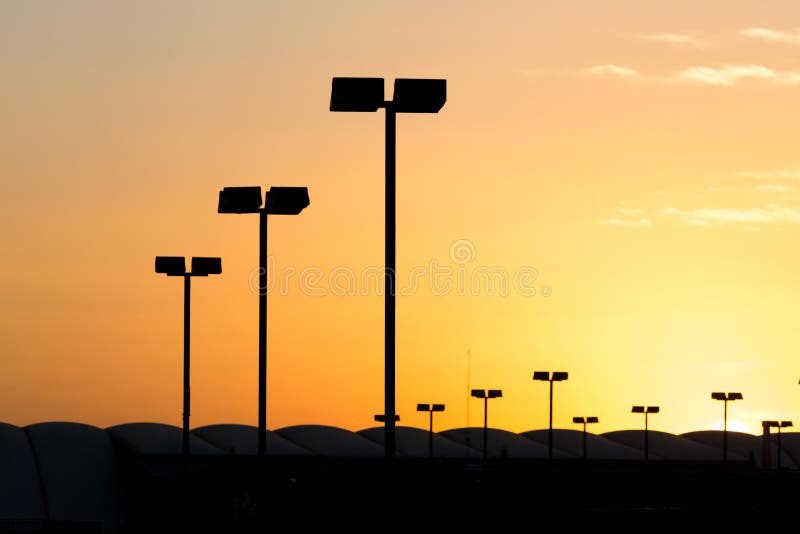 Light poles at sunset stock image. Image of pole, power - 111932813