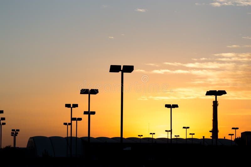 Light poles at sunset stock photo. Image of energy, lighted - 112103212