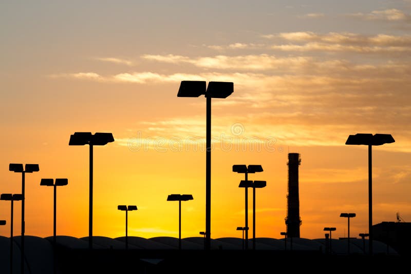 Light poles at sunset stock photo. Image of lamp, silhouette - 112103260