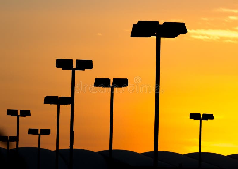 Light poles at sunset stock photo. Image of silhouette - 112103278