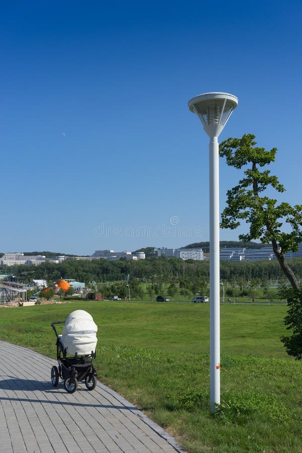 A Light Pram Stands at the Lantern on the Sidewalk. Stock Image - Image ...