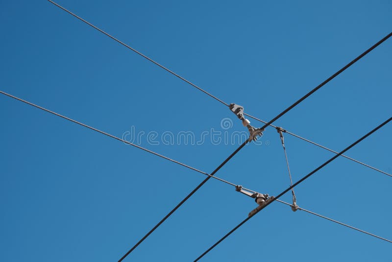 Light Rail Train Cables Cross in Clear Blue Sky Stock Photo - Image of ...