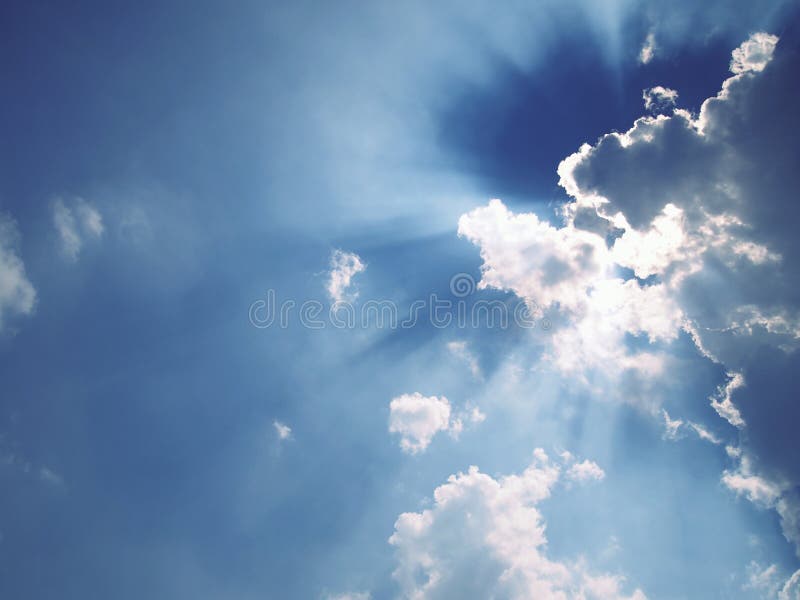 Light Ray from Sun Behind Cloud in the Blue Sky Stock Photo - Image of ...