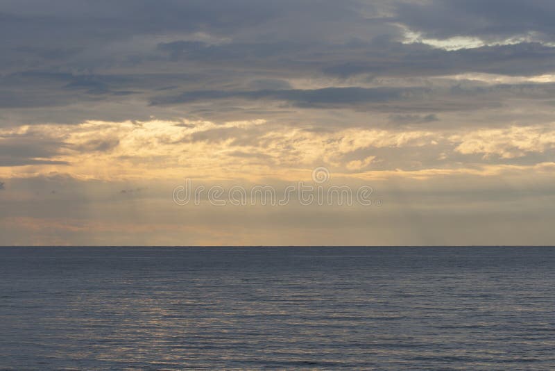 Light Rays Falling through Clouds on the Sea Surface Stock Photo ...