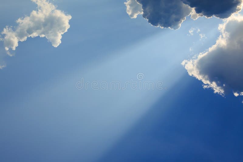 Light Rays of Sun Beam through Clouds in Clear Blue Sky Stock Image ...