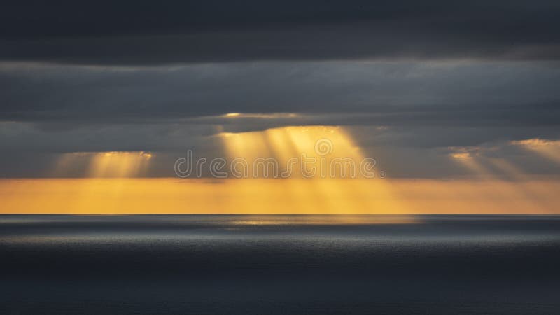Light Rays Shining through Clouds Over the Ocean in Australia Stock ...