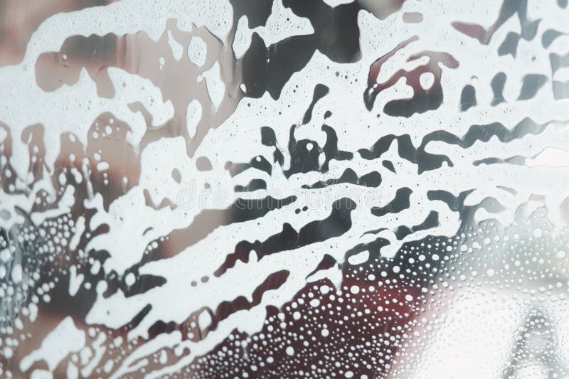 Light Rays Shining through Soap Pour Down the Glass Windshield. Car ...