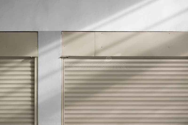 Light and Shadow on Part of 2 Beige Steel Roller Shutter Doors of ...
