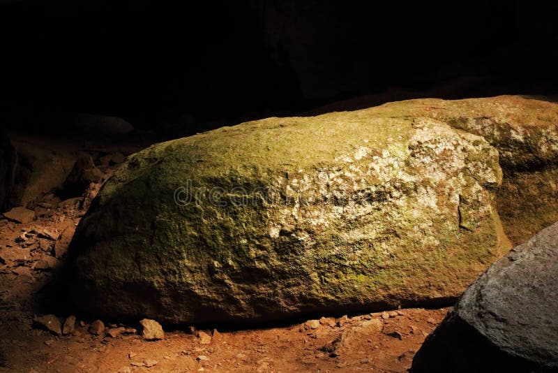 LIGHT from a SHAFT in a CAVE ROOF FALLING on a ROCK Stock Photo - Image ...