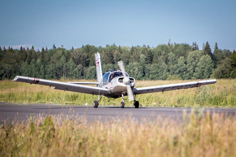 Light Single-engine Aircraft in White Accelerates for Takeoff Editorial ...