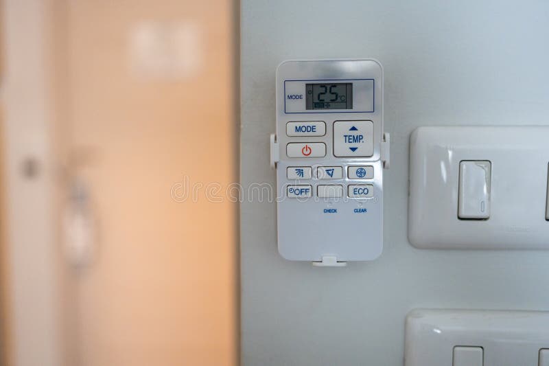 Light Switch and Air Conditioner Remote Control on White Wall Stock ...