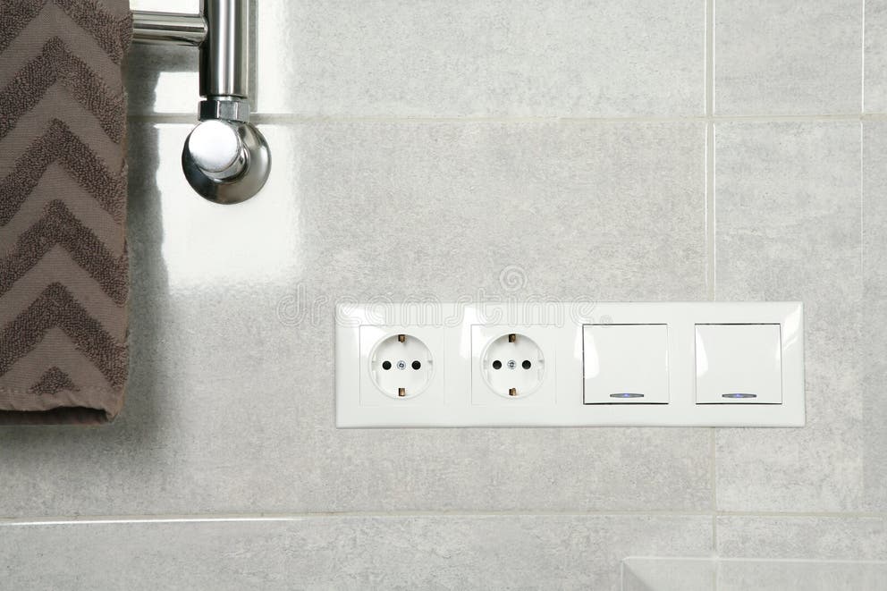 Light Switches and Power Sockets on Light Grey Wall in Bathroom Stock ...