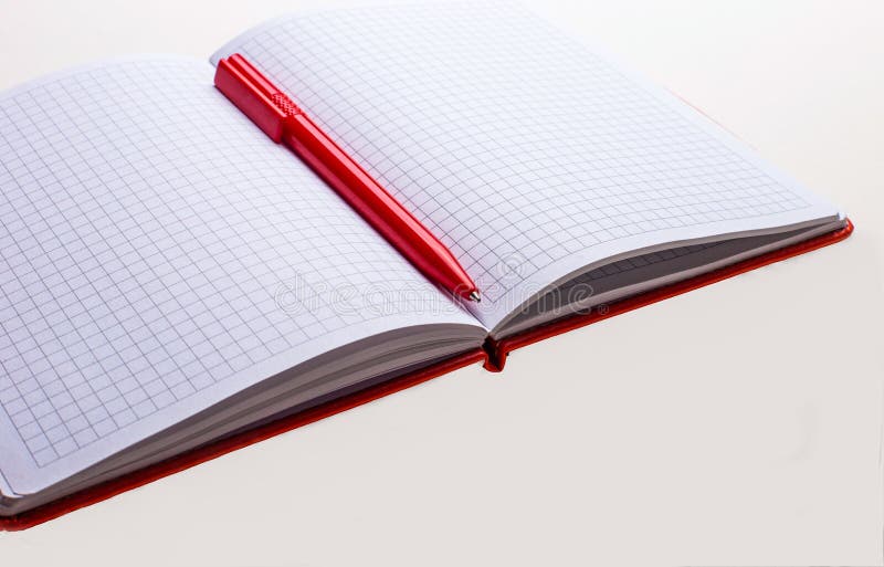On a Light Table Lies an Open, Blank Notebook with a Red Cover and a ...