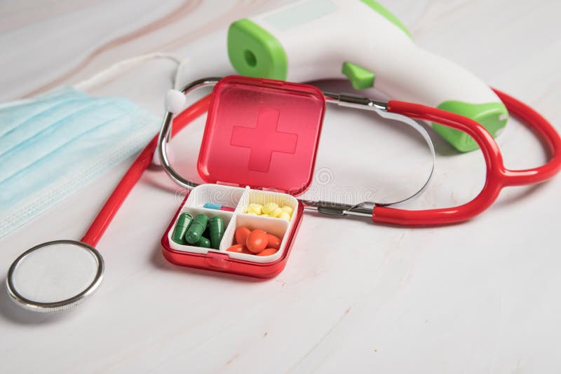 On a Light Table There is an Infrared Thermometer Box with Vitamins and ...