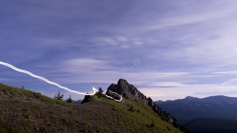 Light Trail Running Along Ridge of Mountain at Night Stock Image ...