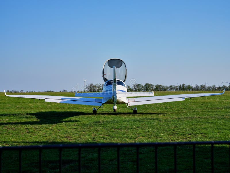 Light White Aircraft with an Open Cockpit after Landing on the Grass ...