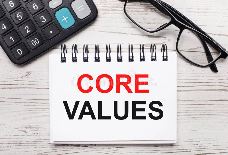 On a Light Wooden Table Calculator, Glasses and a Blank Notepad with ...