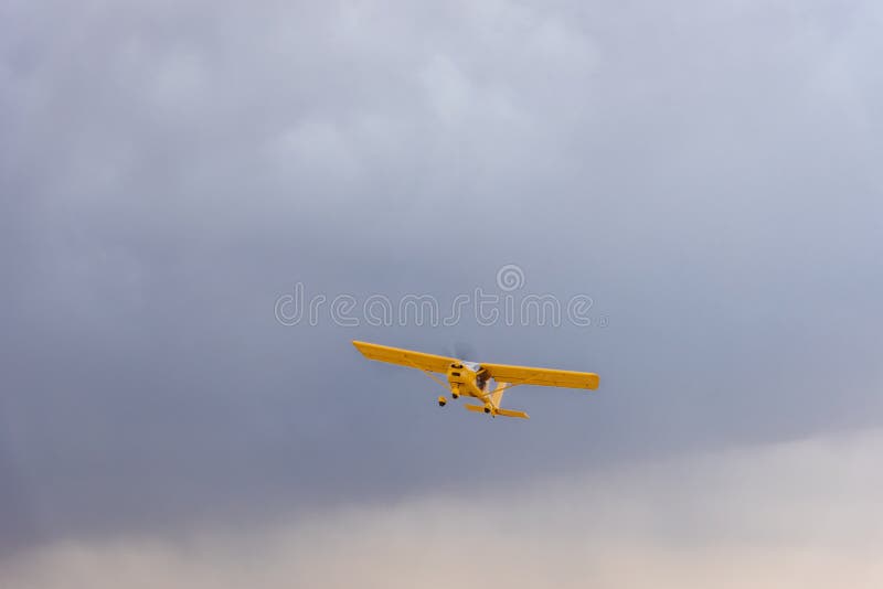 Light Yellow Turboprop Aircraft Flies Across the Sky among the Clouds ...
