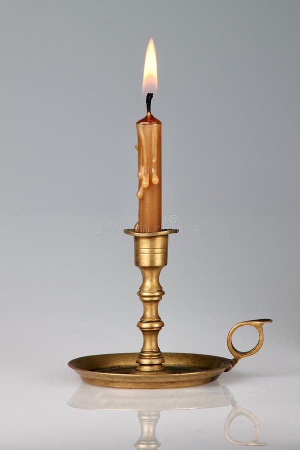 Lighted Candle in an Old Brass Candlestick. Stock Photo - Image of ... Lighted Candle in an Old Brass Candlestick. Stock Photo - Image of ...