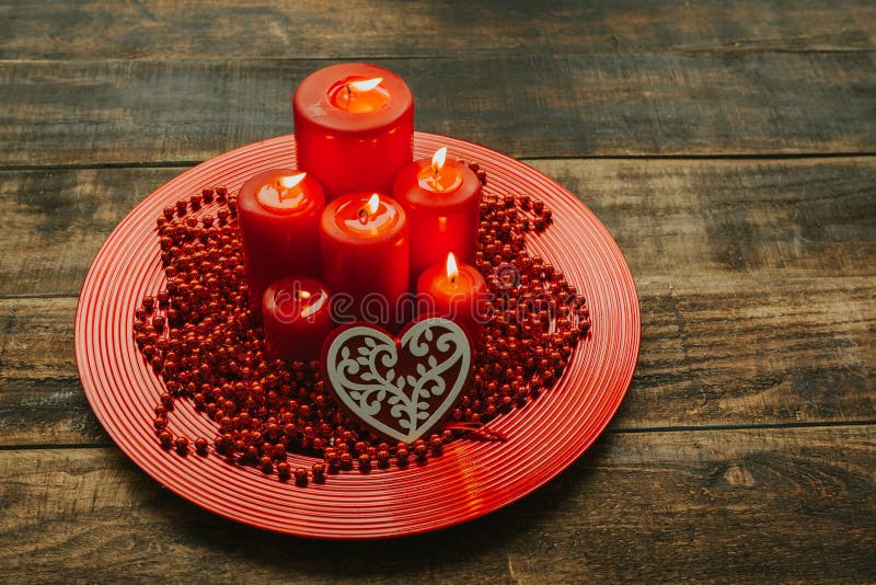 Lighted Candles with Red Colored Pearls Around Stock Photo - Image of ...
