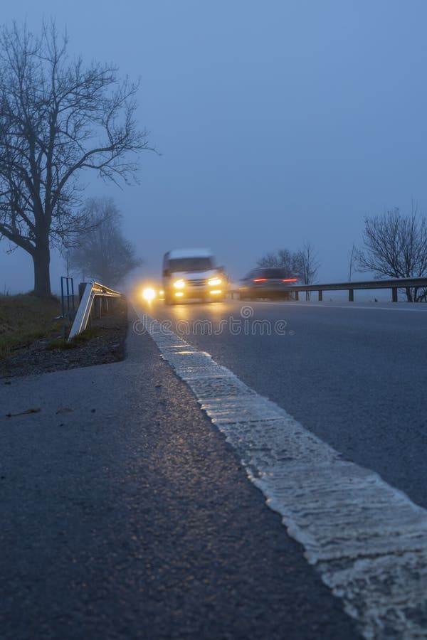 Lighted Cars at Dusk on Main Road Stock Photo - Image of sundown, line ...
