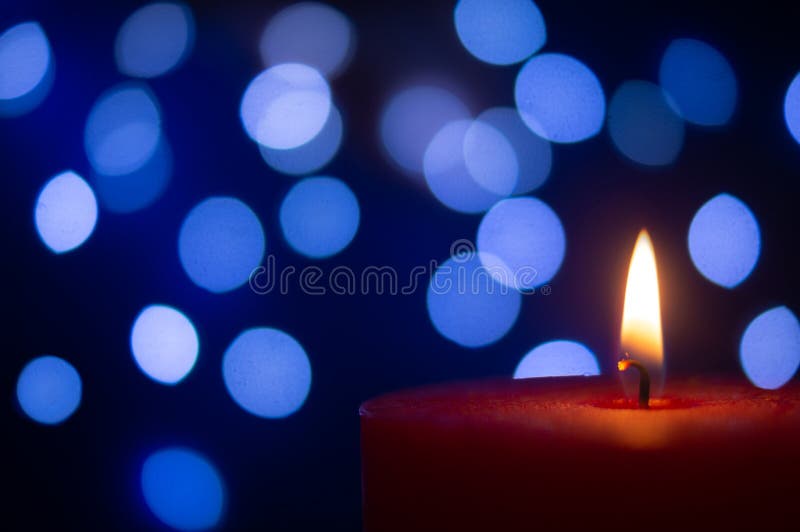 Lighted Candle on the Blurred Light Blue Spots Background Stock Photo ...