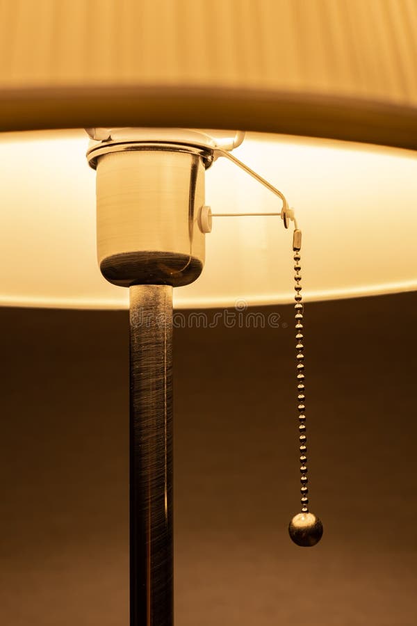 Lighted Lamp Standing in the Dark on the Background of the Wall Stock ...