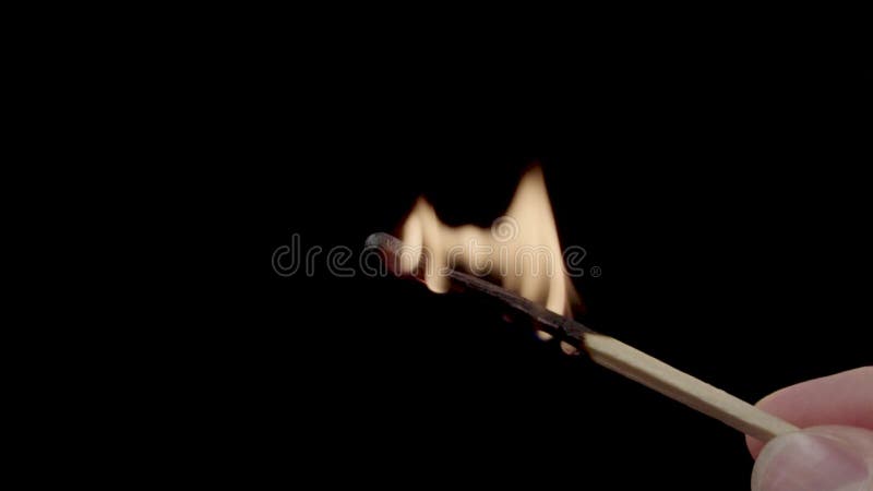 A Lighted Match on a Black Background. Hold a Lighted Match. the Fire ...