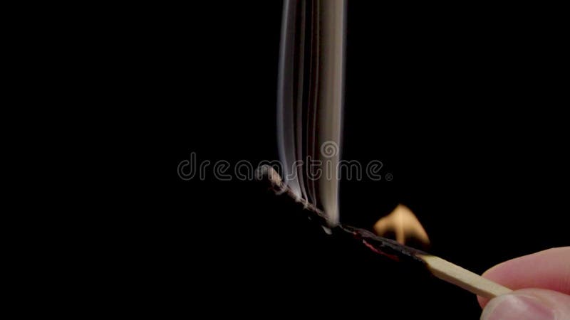 A Lighted Match Burns with Smoke on a Black Background. Concept of Slow ...