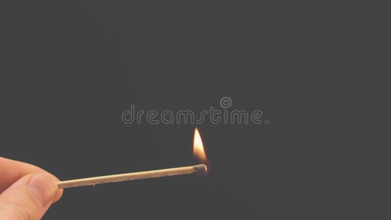 A Lighted Match Burns with Smoke on a Black Background. Concept of Slow ...