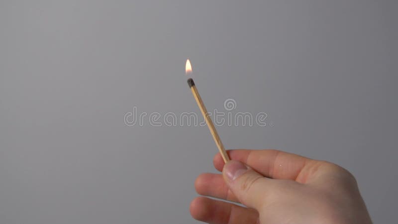 A Lighted Match Burns with Smoke on a Gray Background. Concept of Slow ...