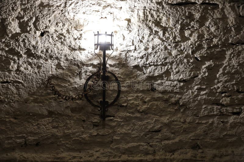 Lighted Medieval Castle Torch Hanging on a Stone Wall, Vintage Objects ...