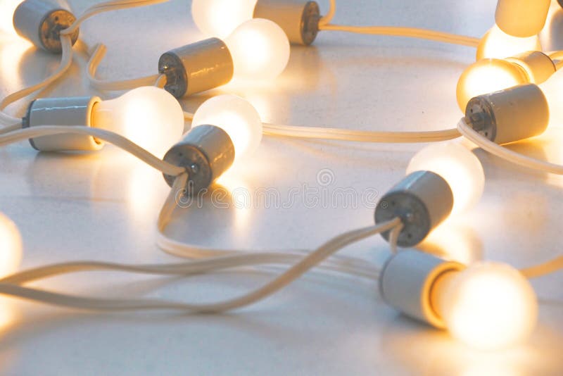 Lighted White Bulbs Joined by a Continuous Cable Stock Photo - Image of ...
