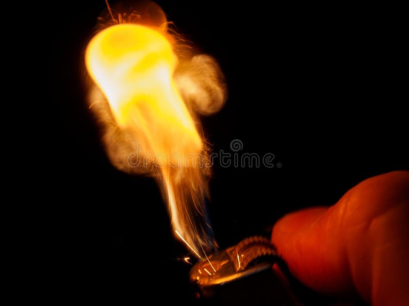 The Lighter Produces a Spark, Creating Fire. Symbol of Danger ...