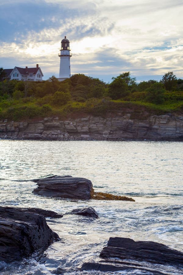 Lighthouse Atop a Jagged, Rocky Cliff Overlooking the Ocean Stock Image ...