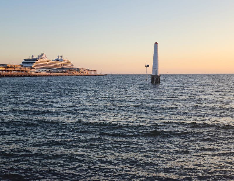 Lighthouse Beacon with Harbour Vessel and Ocean Water during Sunset ...