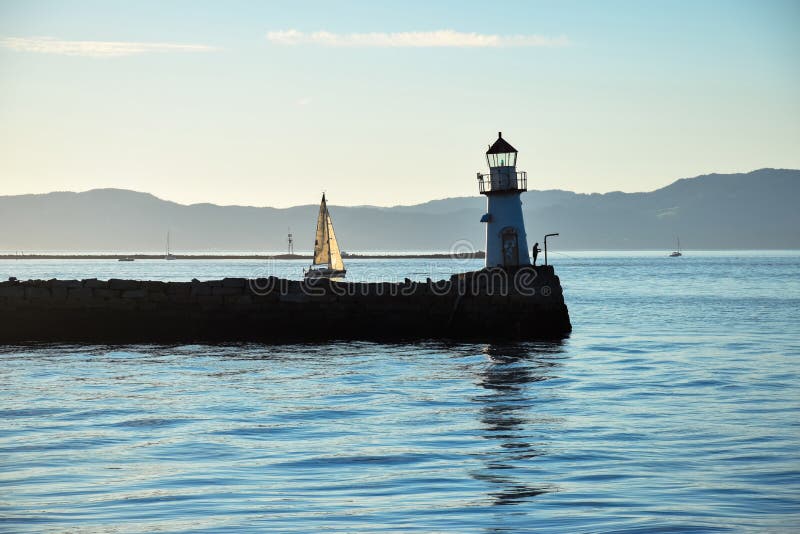 Lighthouse and a boat stock photo. Image of summer, beach - 94567032